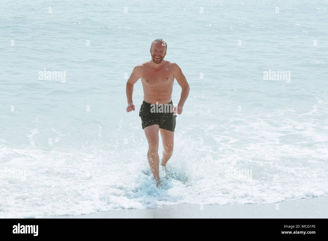 Man running from wave hi-res stock photography and images - Alamy
