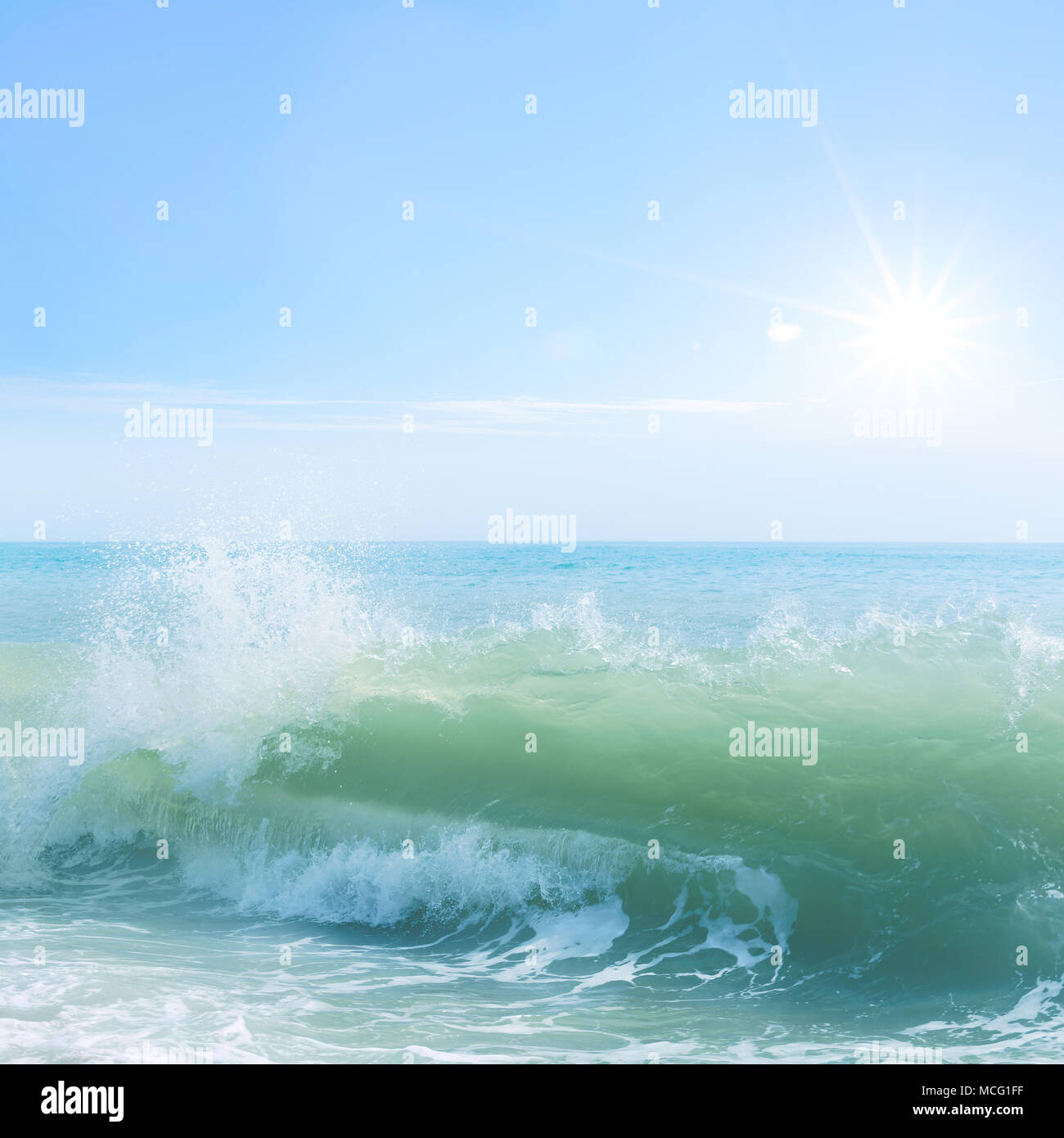 Big blue sea water splash and sun in sky background Stock Photo - Alamy