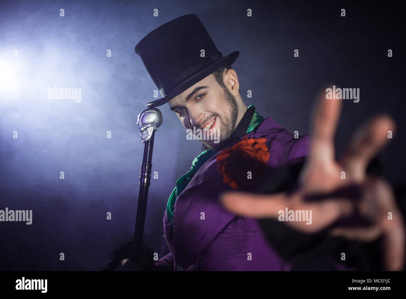 Showman. Attractive man in the cylinder. The hand gesture at the camera ...