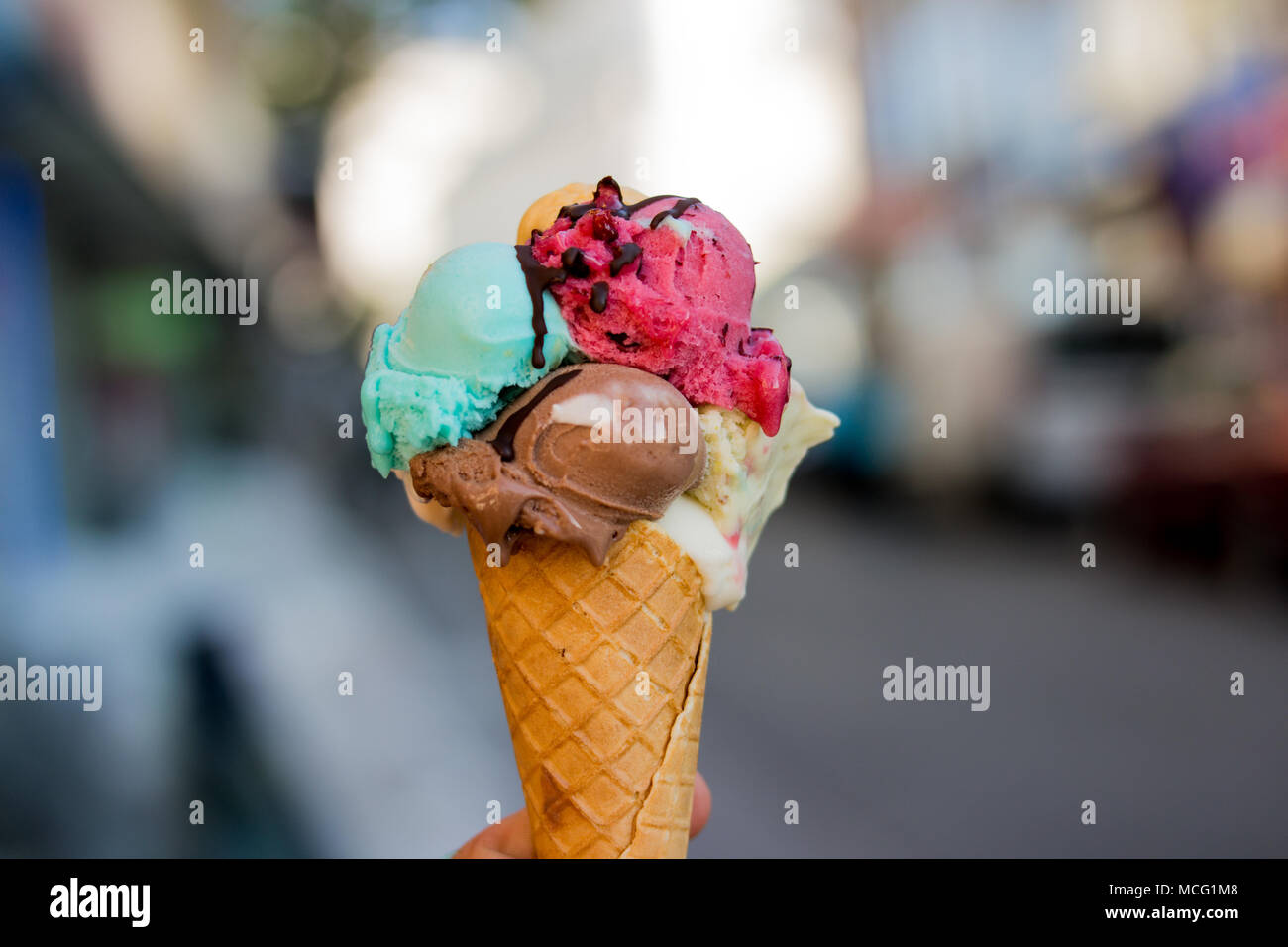 ice cream in cone holding by man Stock Photo - Alamy