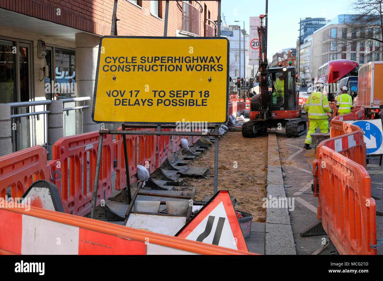 Cycle superhighway construction works sign and workers working on ...