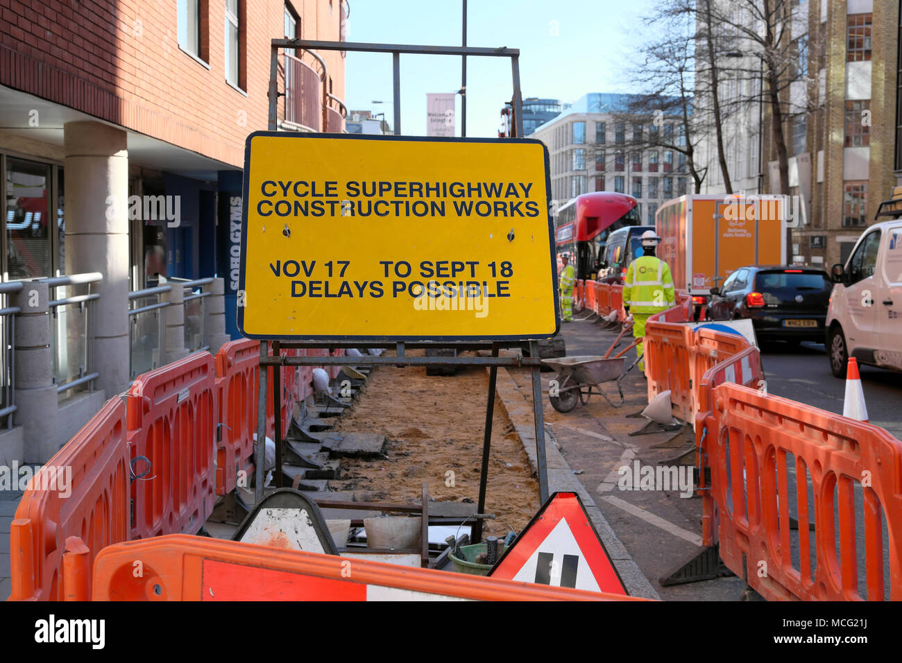 Cycle superhighway construction works sign and workers working on ...