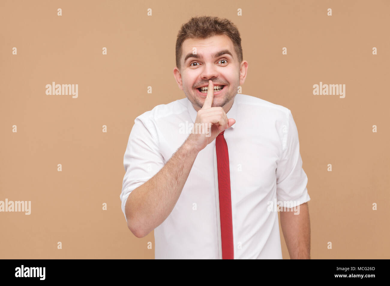 Closeup portrait handsome businessman showing shh sign. Business people ...