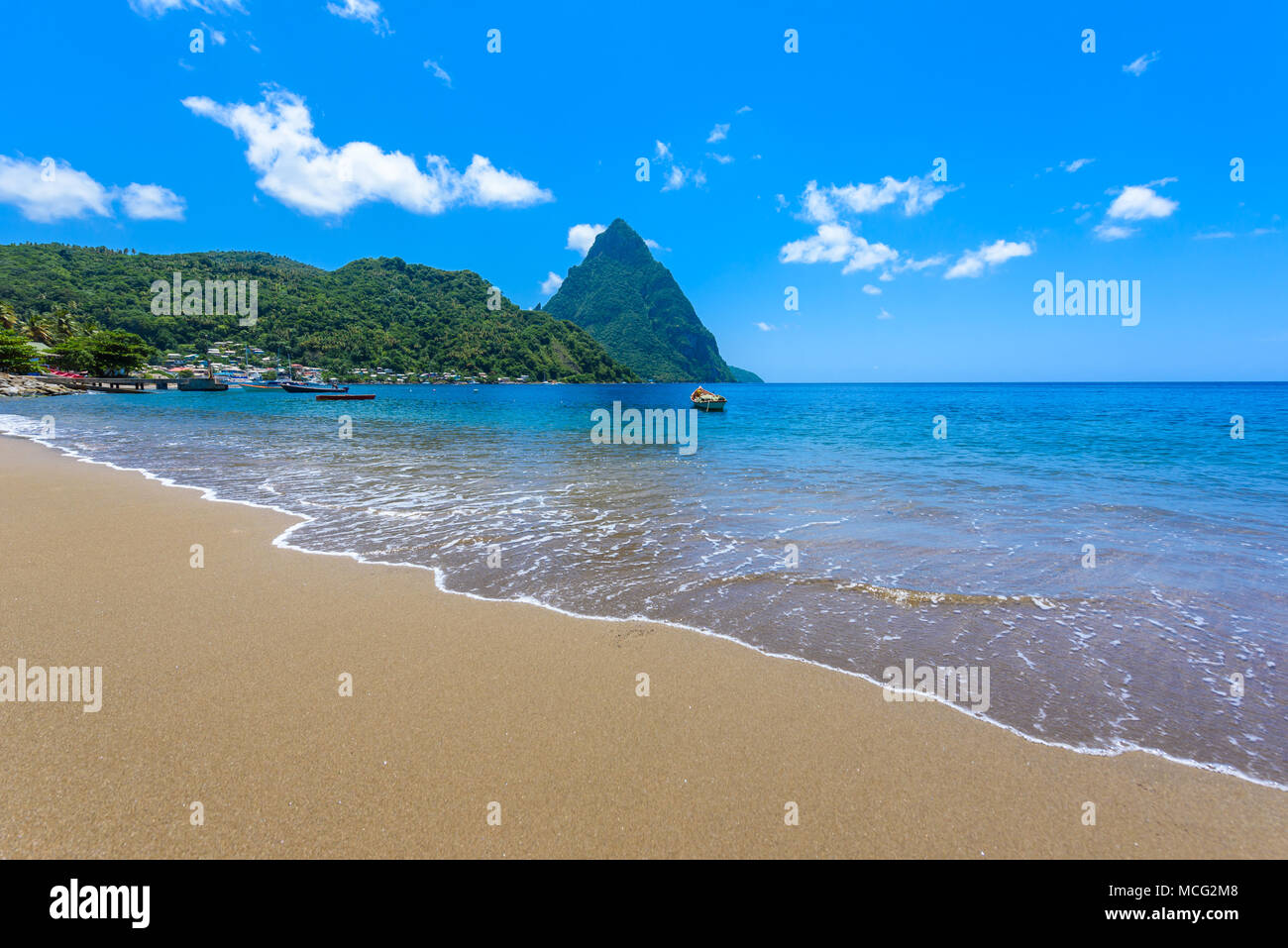 Paradise beach at Soufriere Bay with view to Piton at small town ...