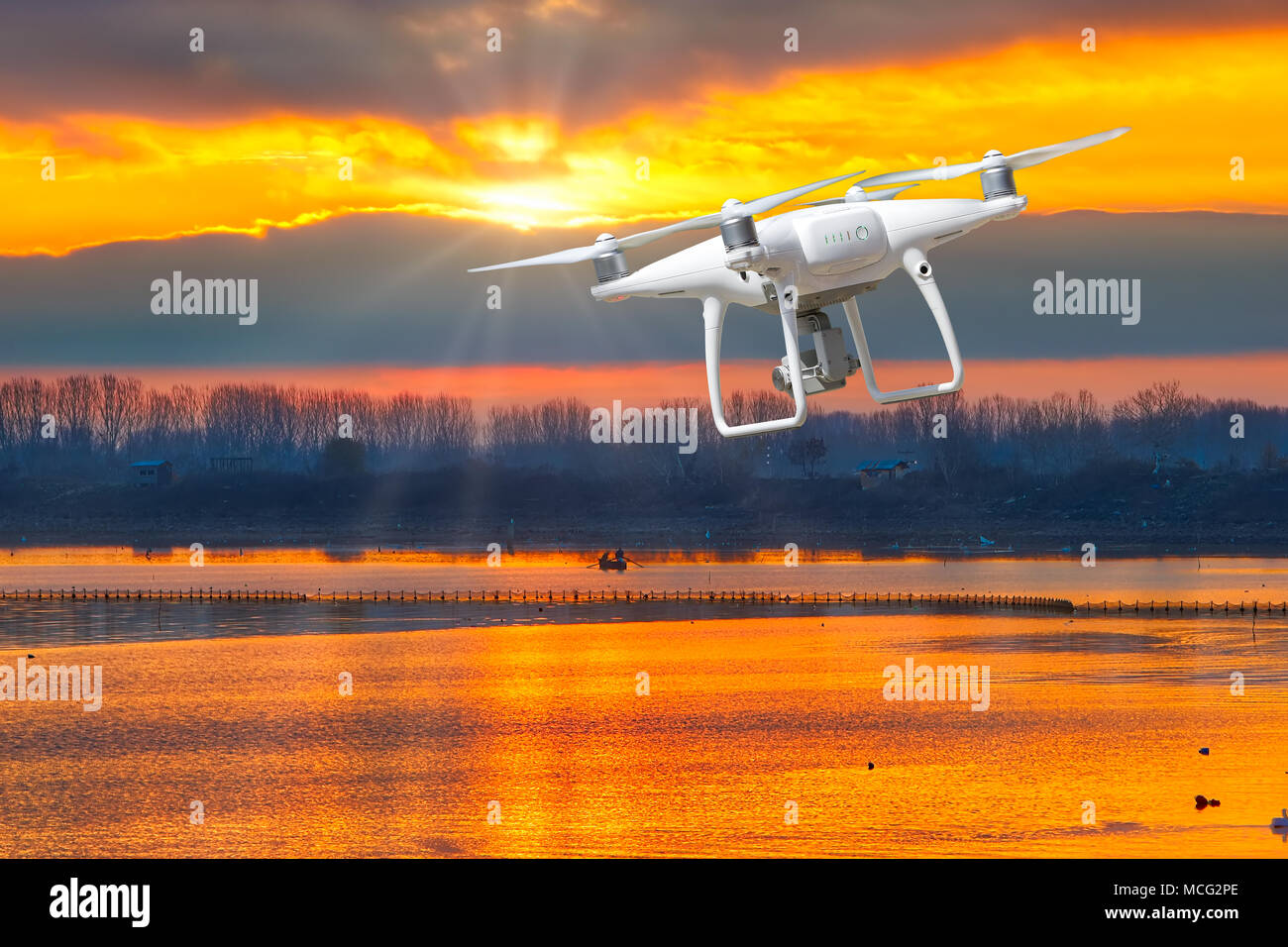 Modern drone watching the beautiful sunset Stock Photo - Alamy