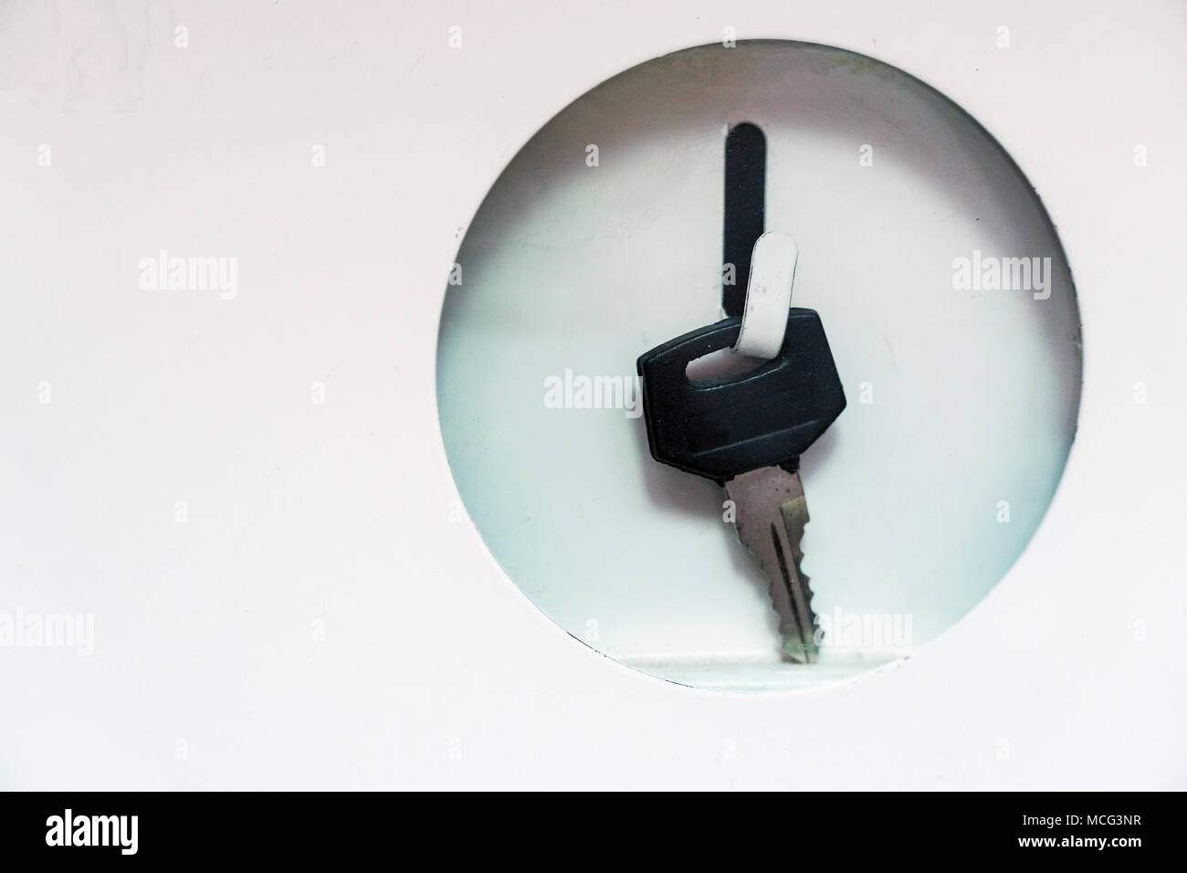Key on the hook in a small round window Stock Photo - Alamy