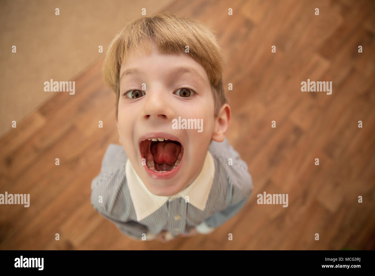 little boy with a mouth open in screaming Stock Photo - Alamy