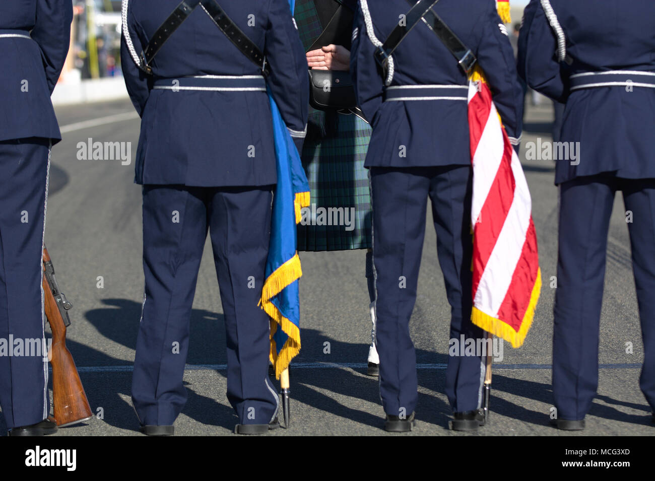 The color guard and a bagpiper stand at parade rest while waiting for ...