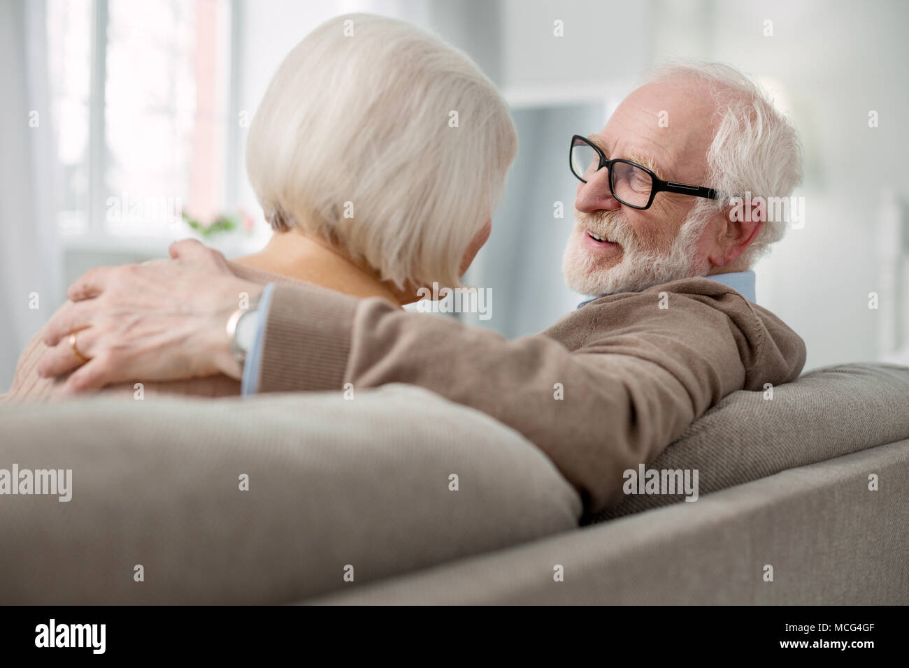 Happy nice man smiling to his wife Stock Photo - Alamy