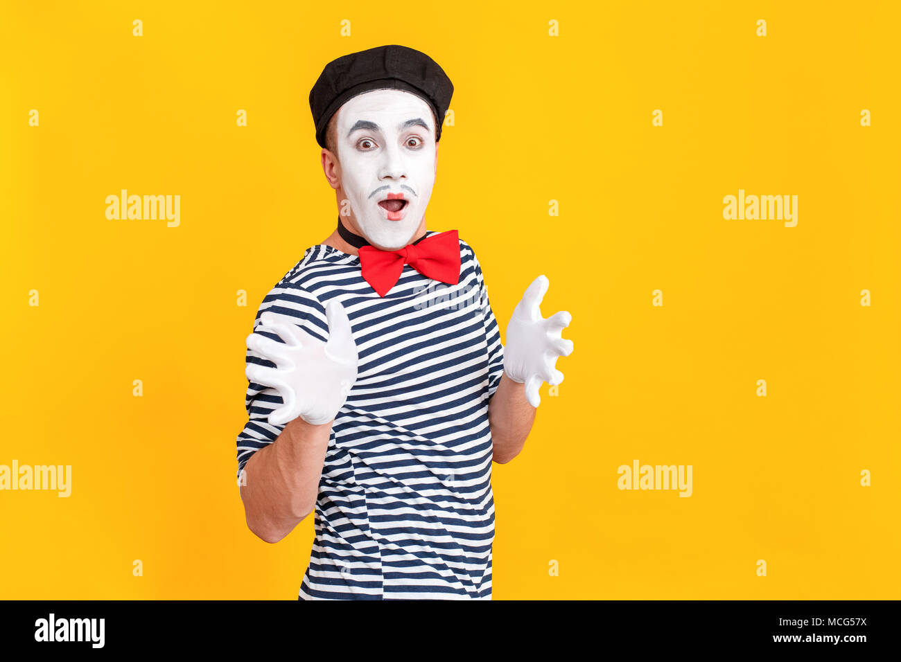 Portrait of wondered mime man looking at camera, little smile. Emotions ...