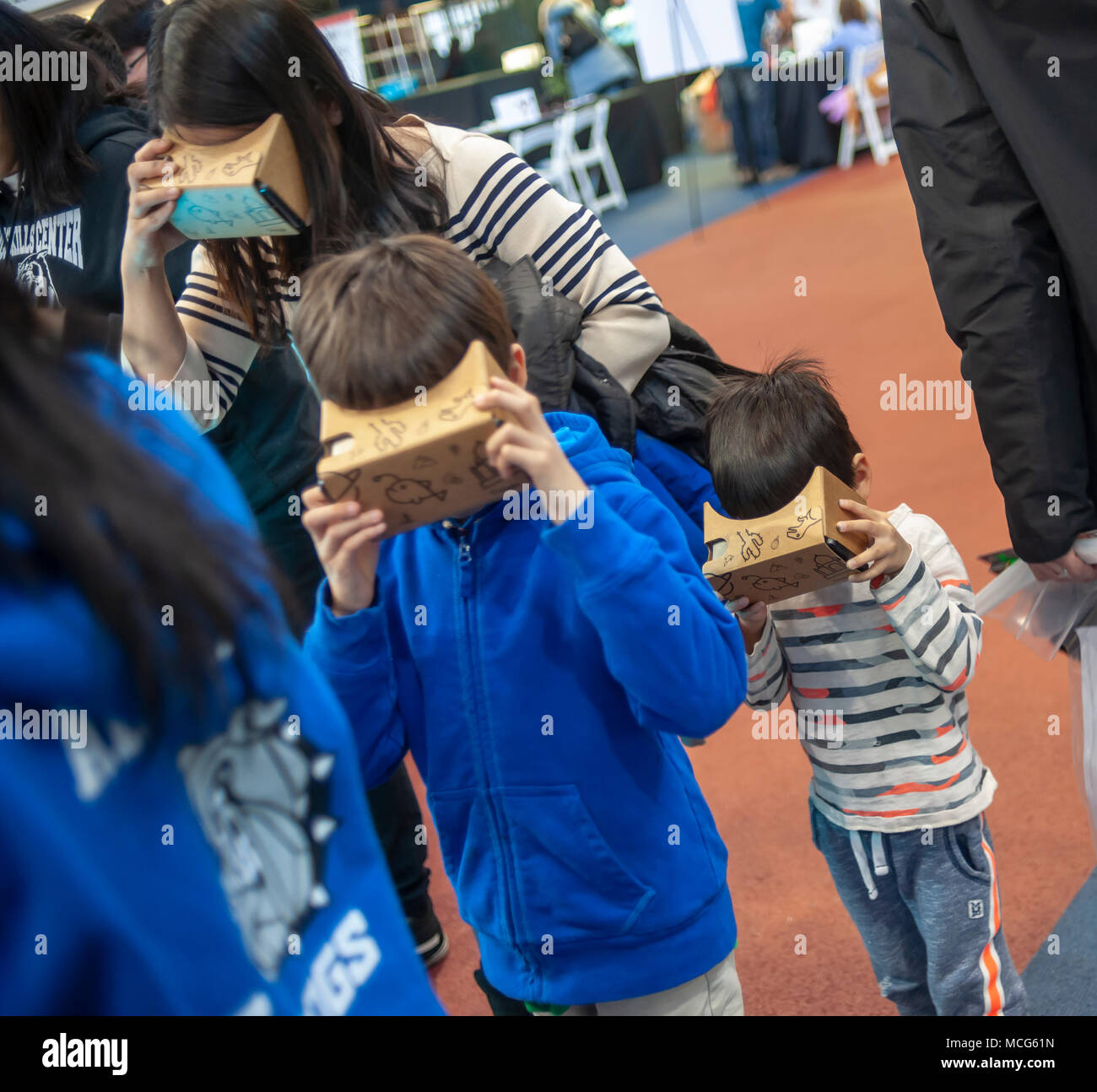 Visitors use Google virtual reality goggles at the Google booth at a ...
