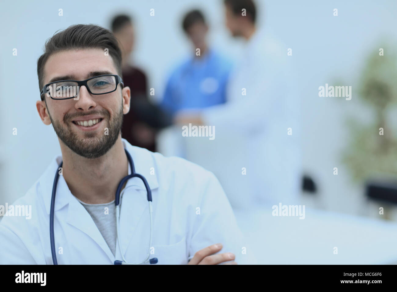 handsome doctor on blurred background Stock Photo - Alamy
