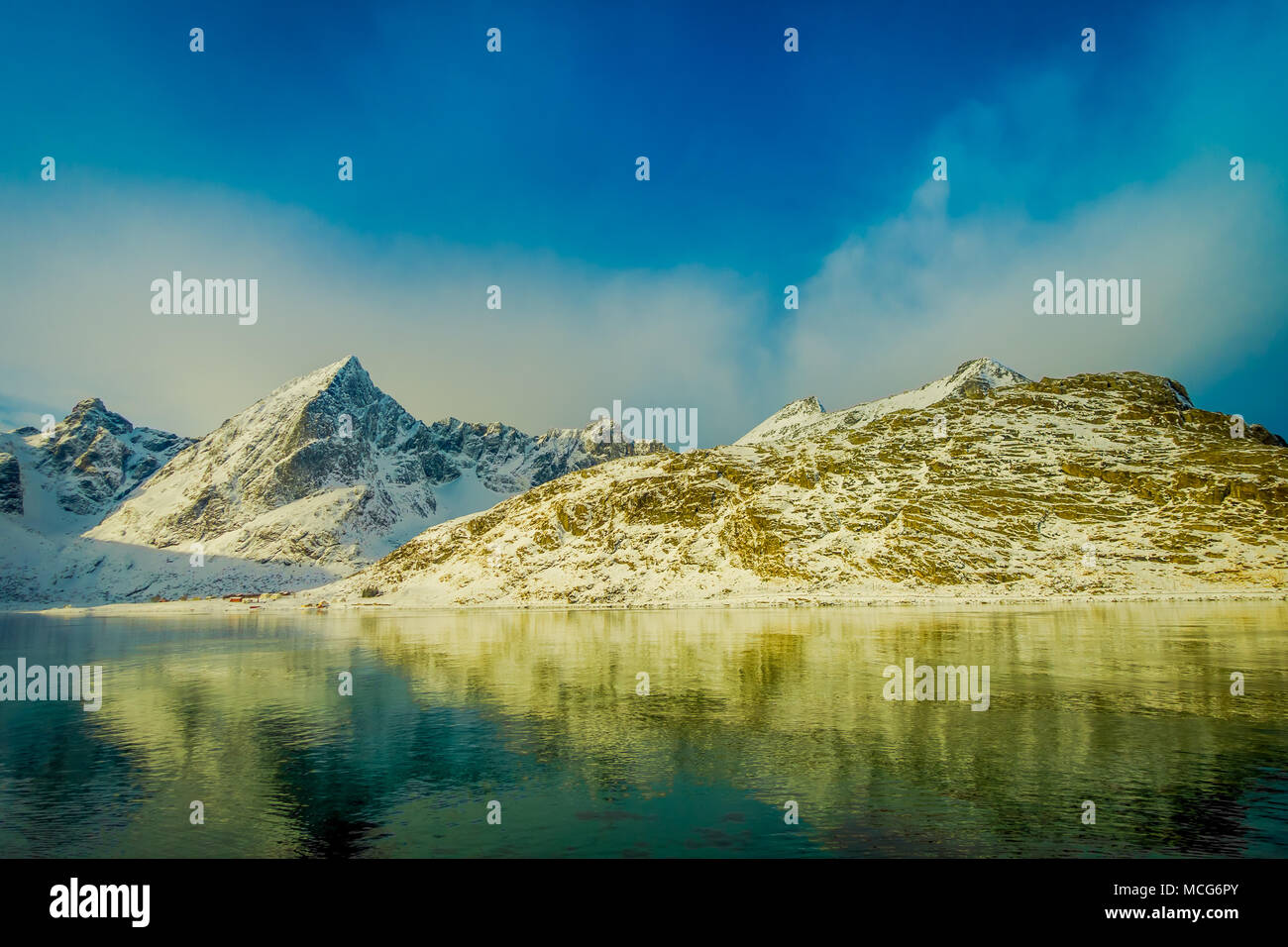 Gorgeous view of mountain peaks and reflection in water on Lofoten ...