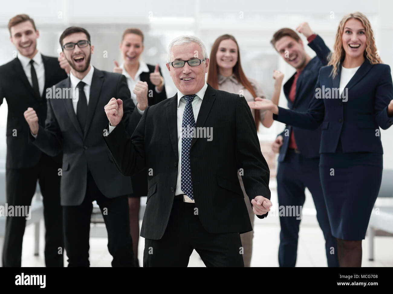 happy senior businessman and triumphant business team Stock Photo - Alamy