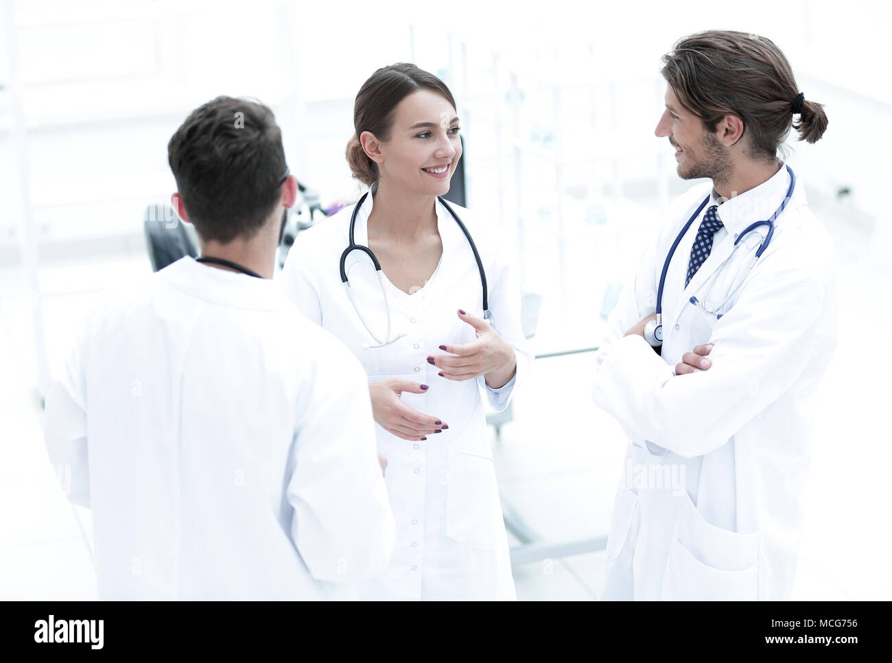 Team of different doctors having conversation Stock Photo - Alamy