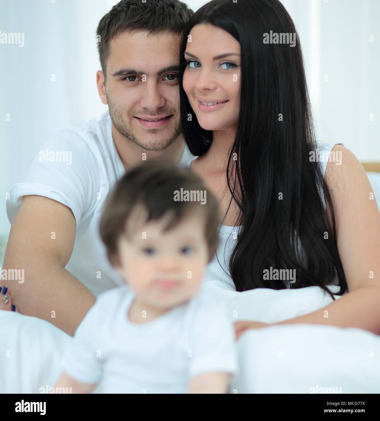 Cute little boy with parents on the bed Stock Photo - Alamy