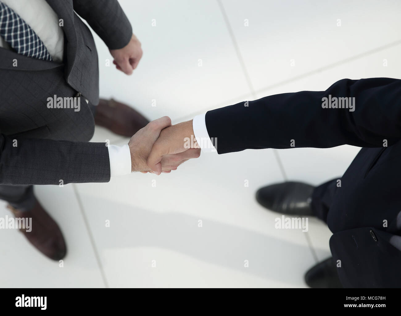 Two business men shaking hands in the office Stock Photo - Alamy