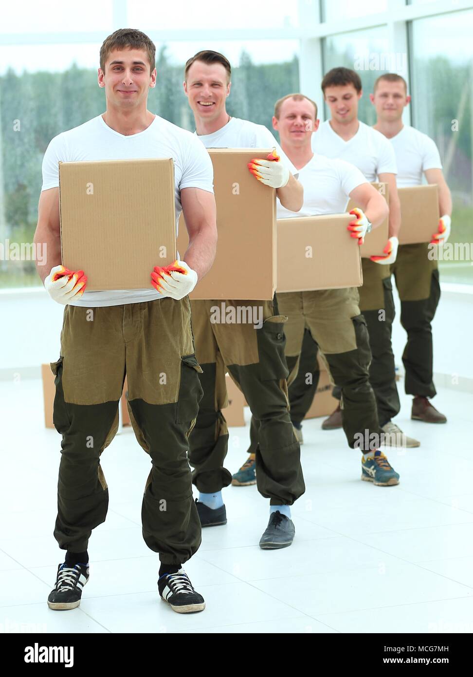 team of builders with boxes of building materials Stock Photo - Alamy