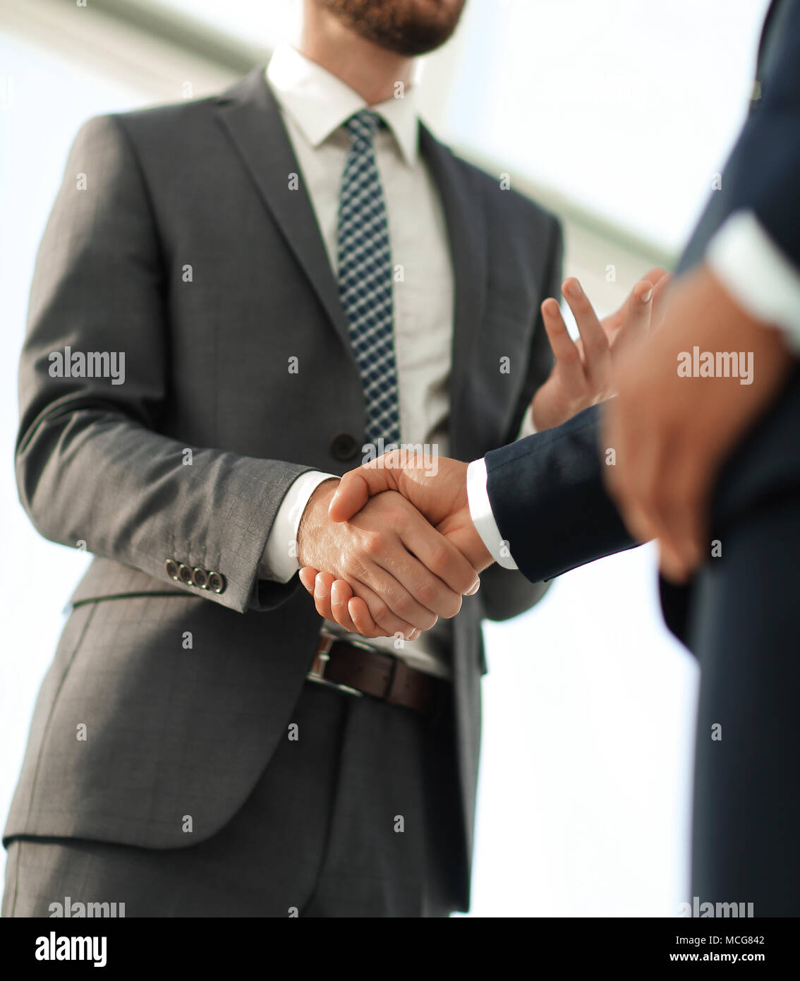 Friendly smiling businessmen handshaking. Business concept photo Stock ...