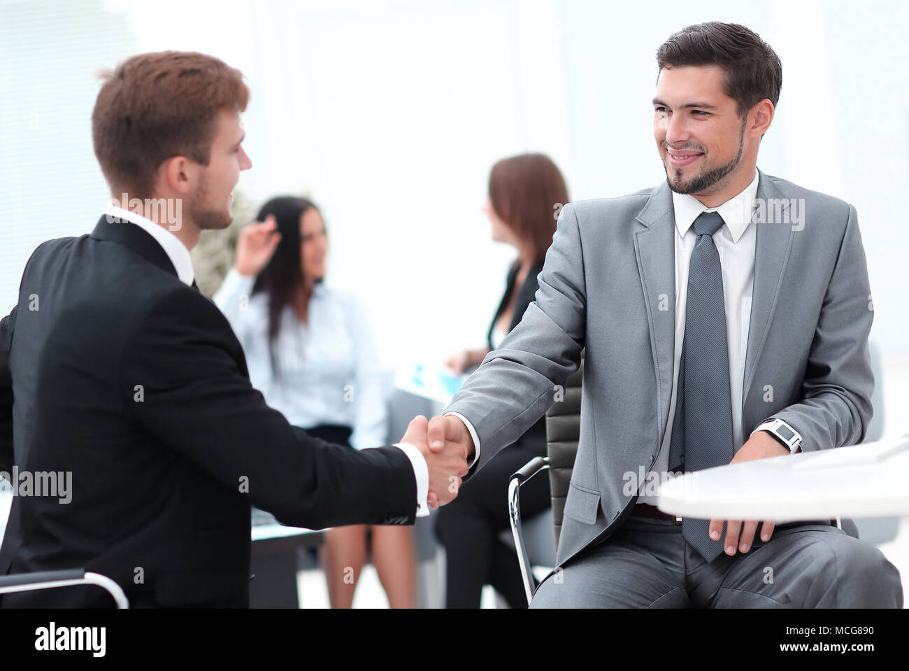 handshake Manager and the client in the office Stock Photo - Alamy