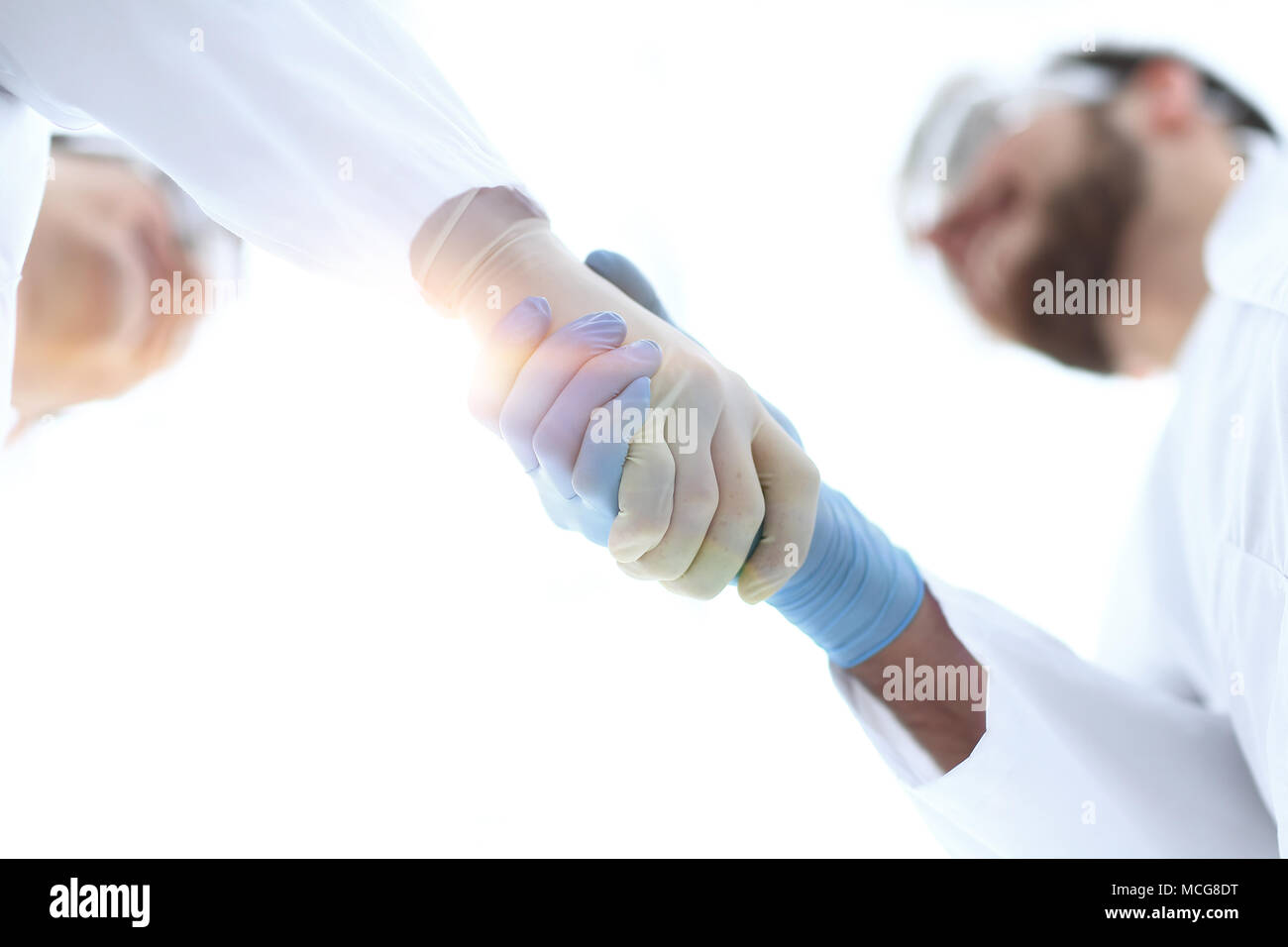 closeup.two scientists shake hands Stock Photo - Alamy