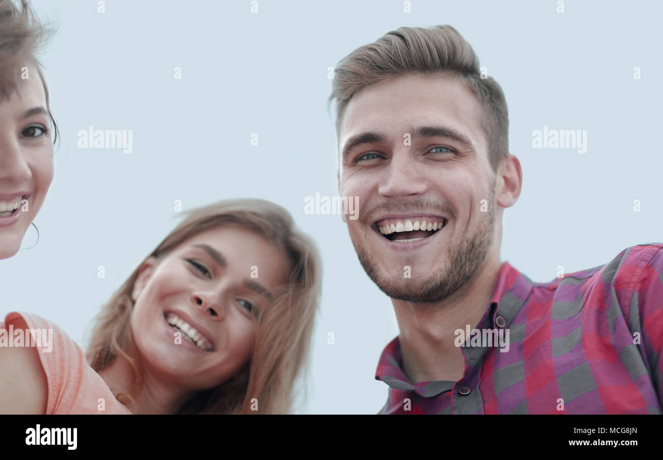 closeup of three young people smiling on white background Stock Photo ...