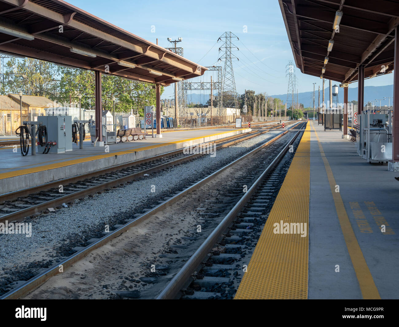 Open air railroad transit center waiting for trains outside at dusk ...