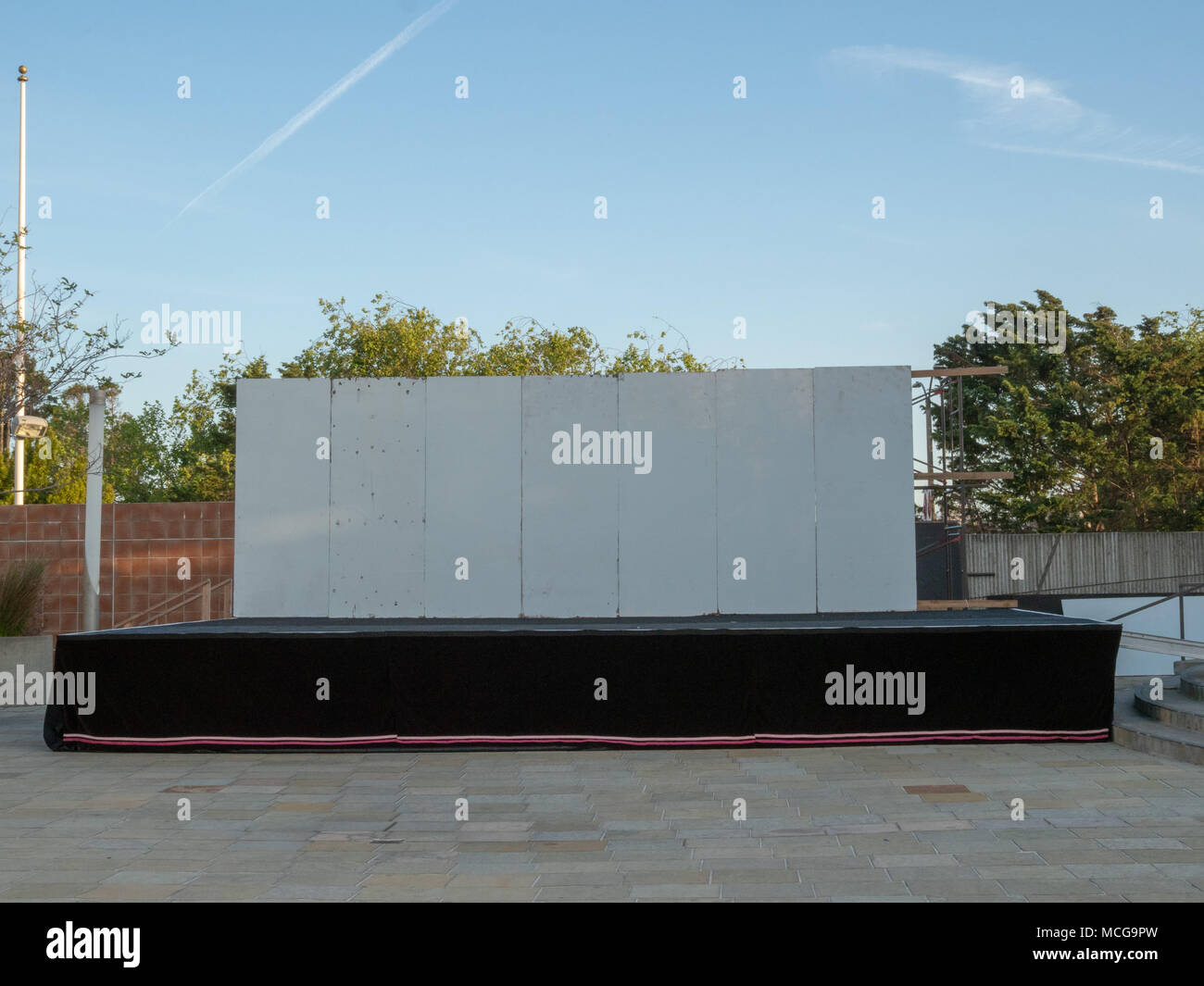 Makeshift empty outdoor stage with white wall ready to use Stock Photo ...