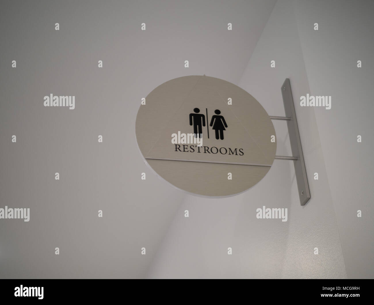 Women/men steel, modern restroom sign hanging high indoors Stock Photo ...