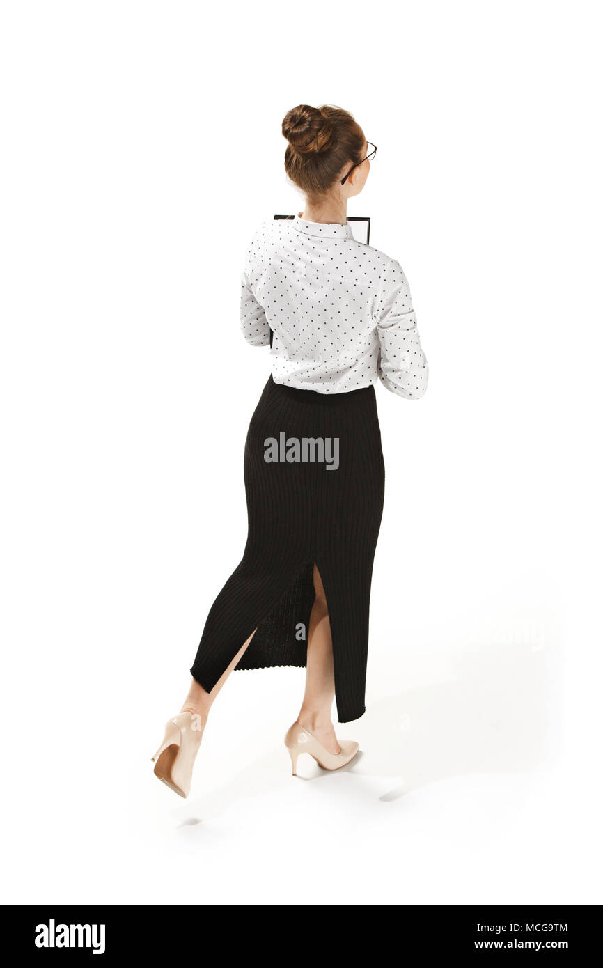 Full length portrait of a back of female teacher holding a folder ...