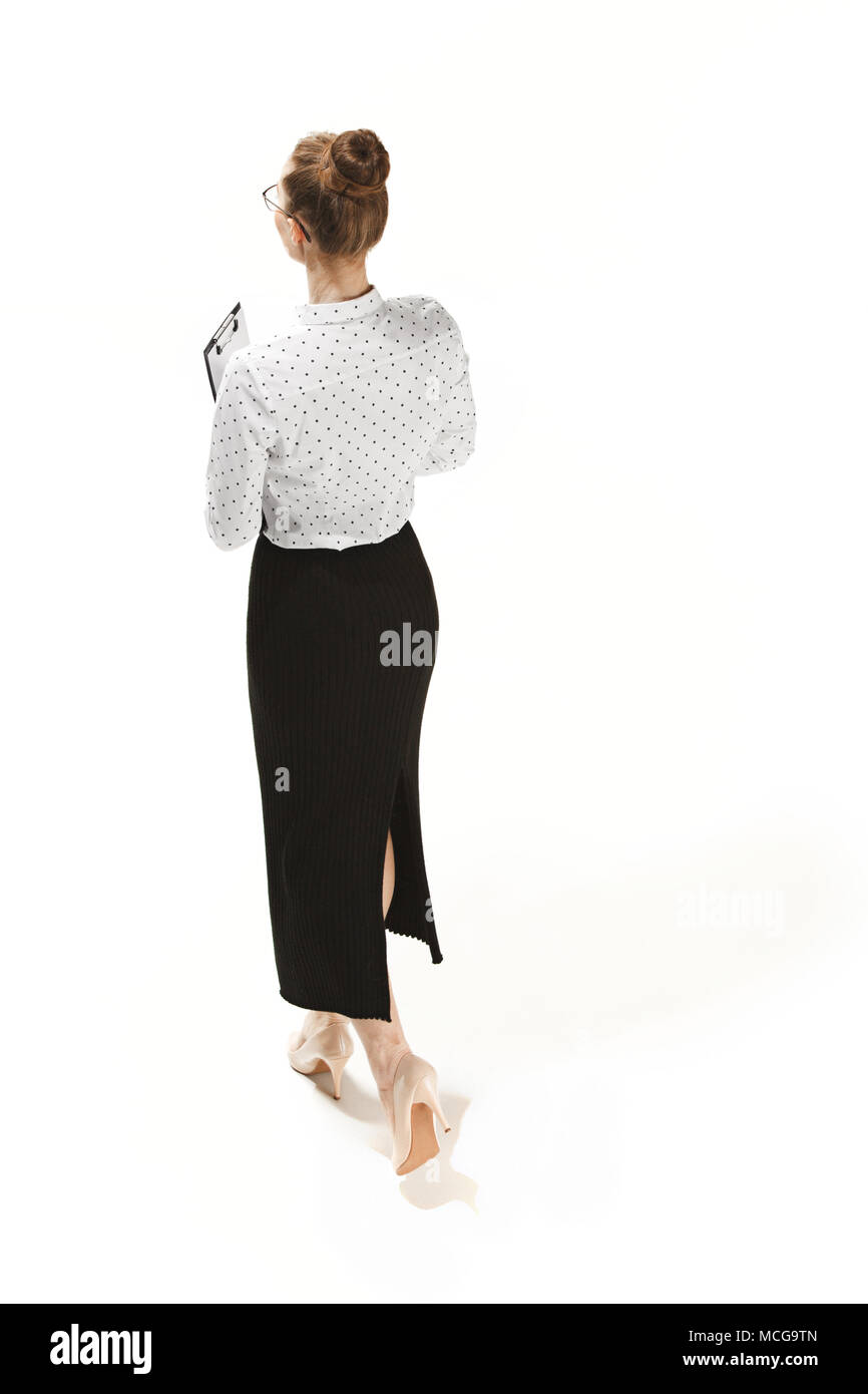Full length portrait of a back of female teacher holding a folder ...