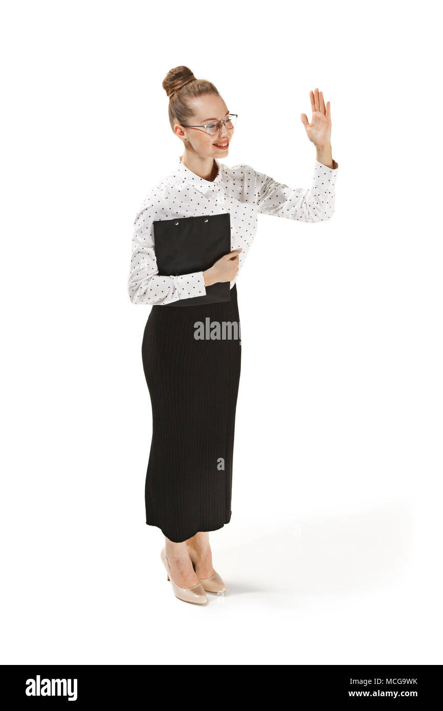 Full length portrait of a female teacher holding a folder isolated ...