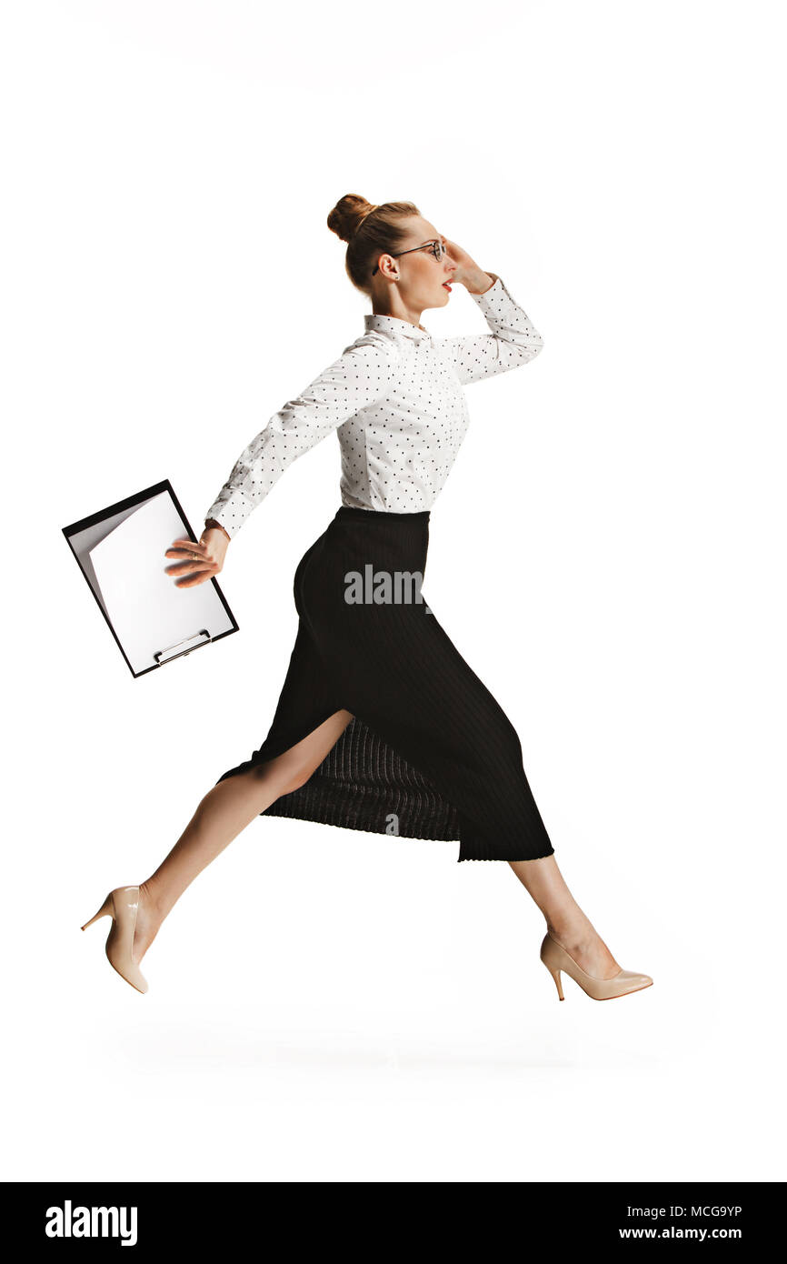 Full length portrait of a smiling female teacher holding a folder ...