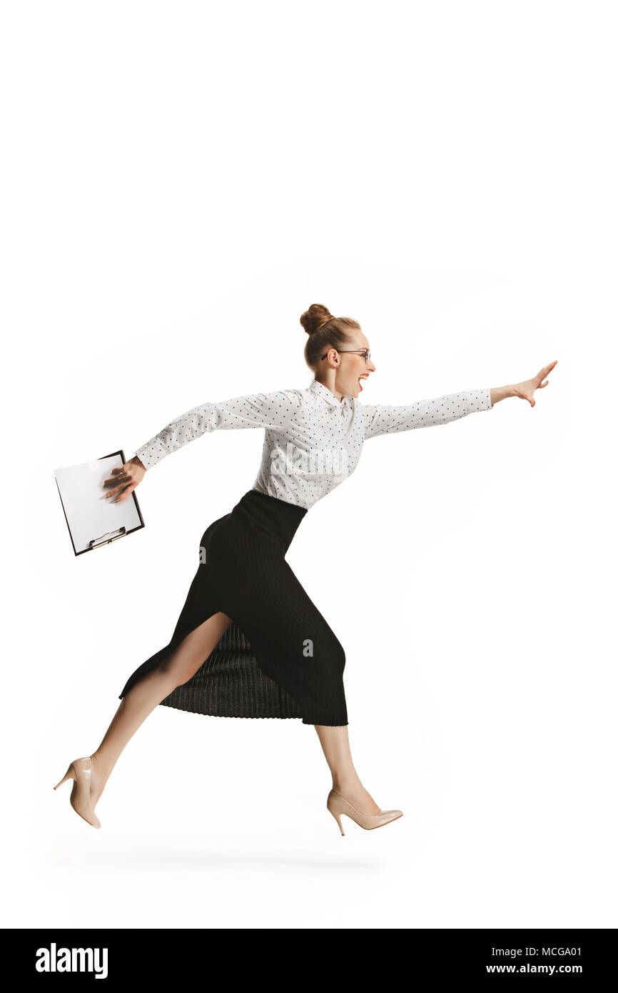 Full length portrait of a smiling female teacher holding a folder ...