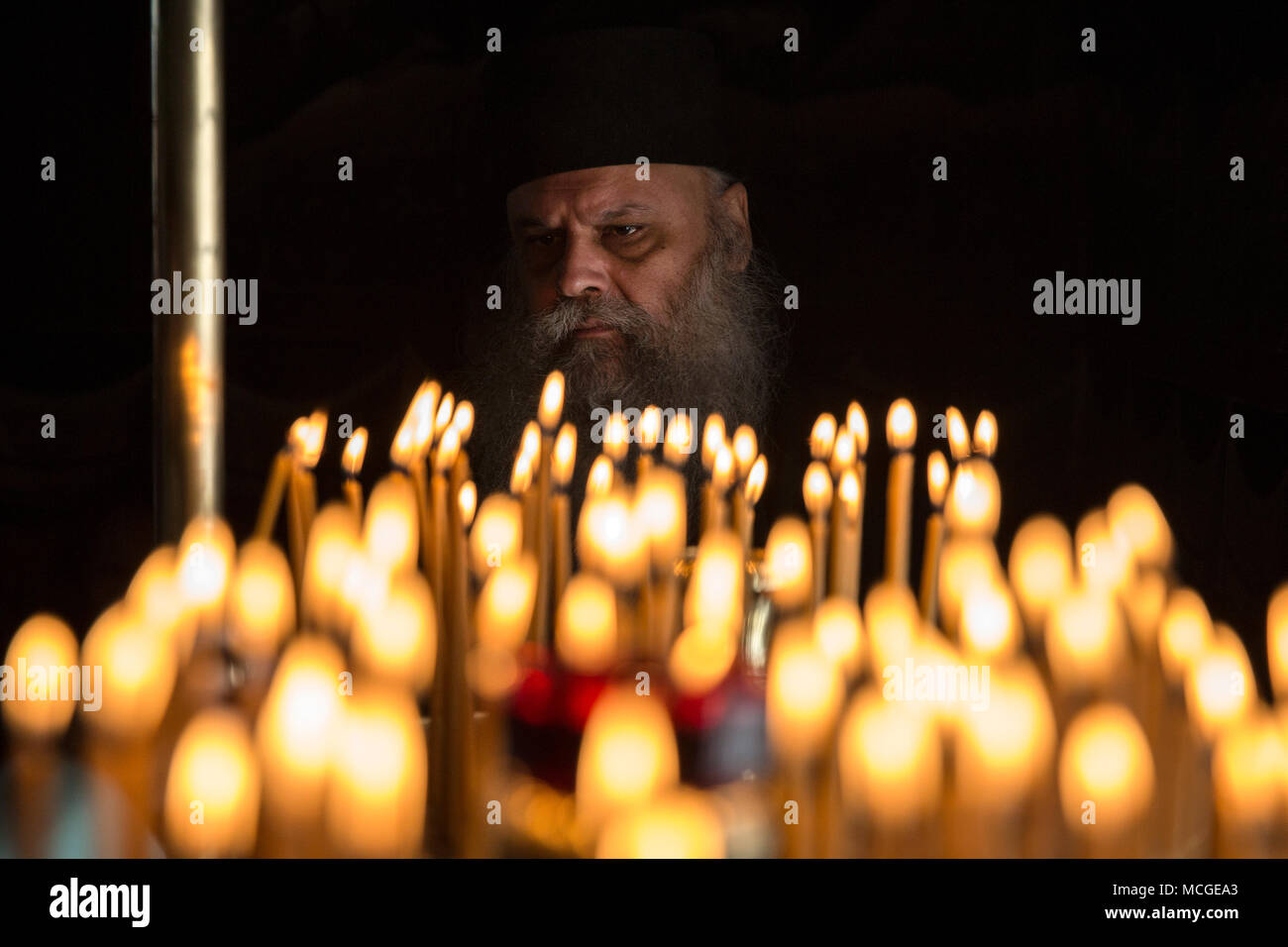 06 April 2018, Greece, Athens: A Greek Orthodox priest stands infront ...