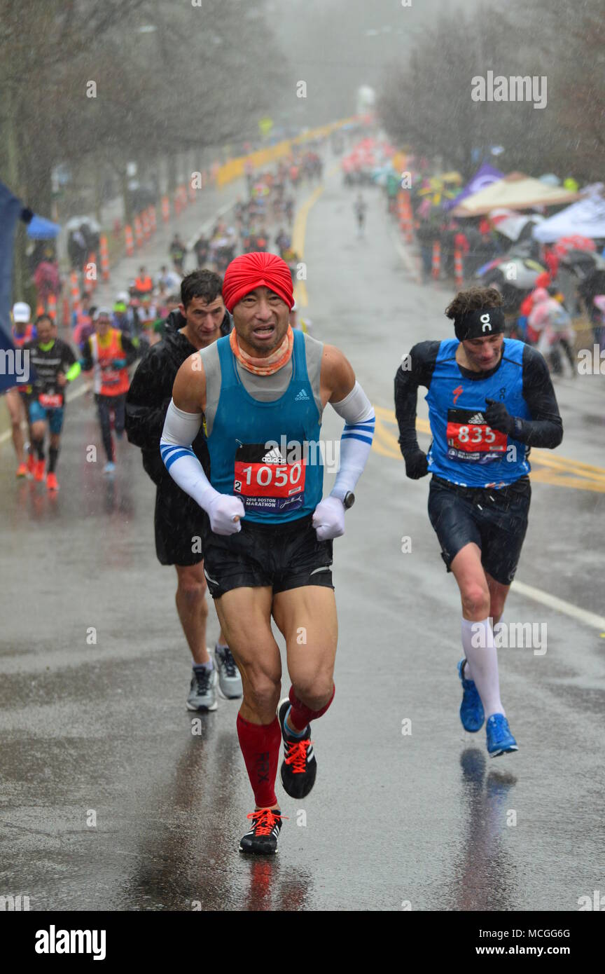 Newton, MA, USA April 16, 2018 Marathon runner tackle the stormy ...
