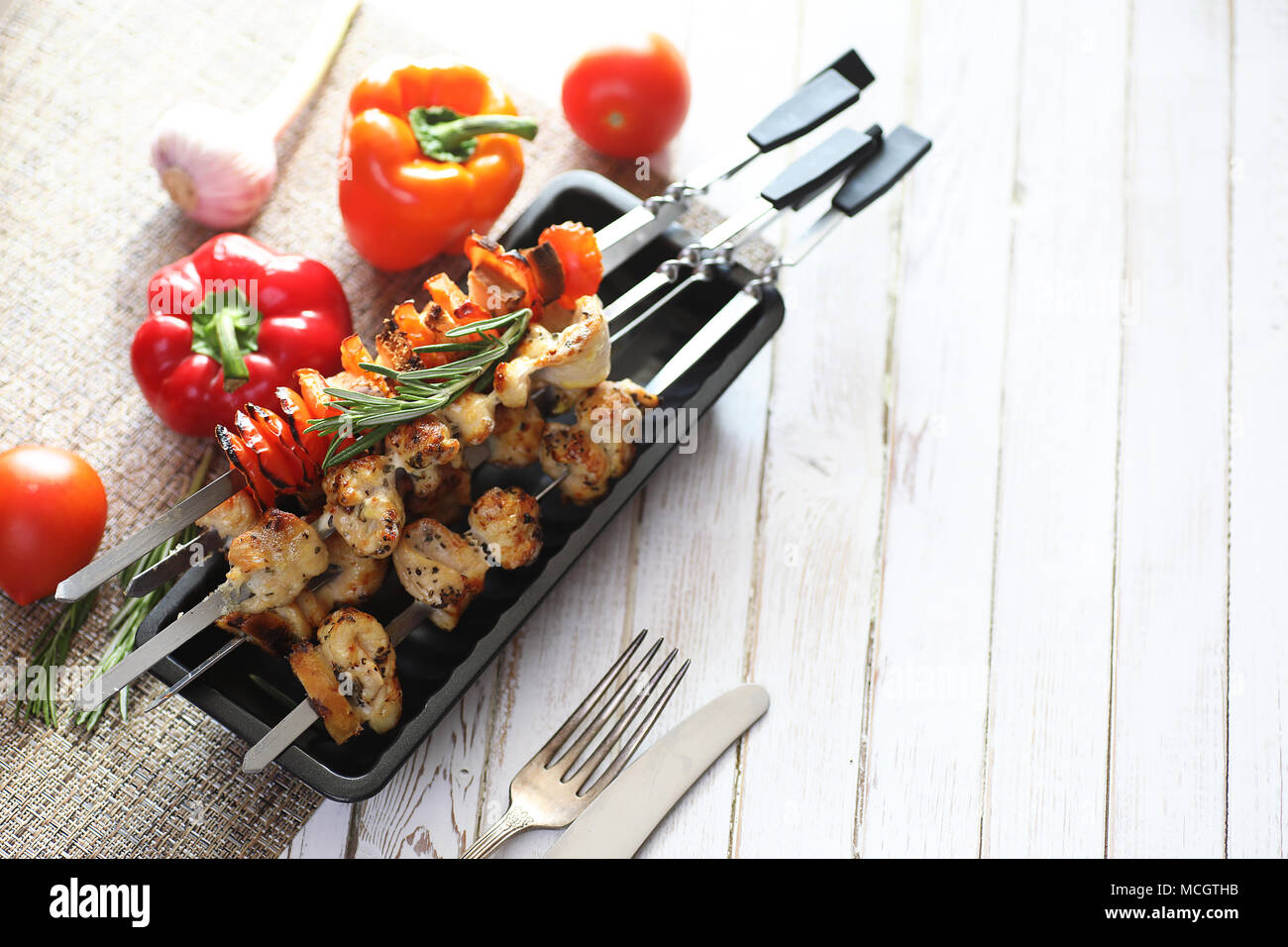Kebab cooked on metal skewers with vegetables Stock Photo - Alamy