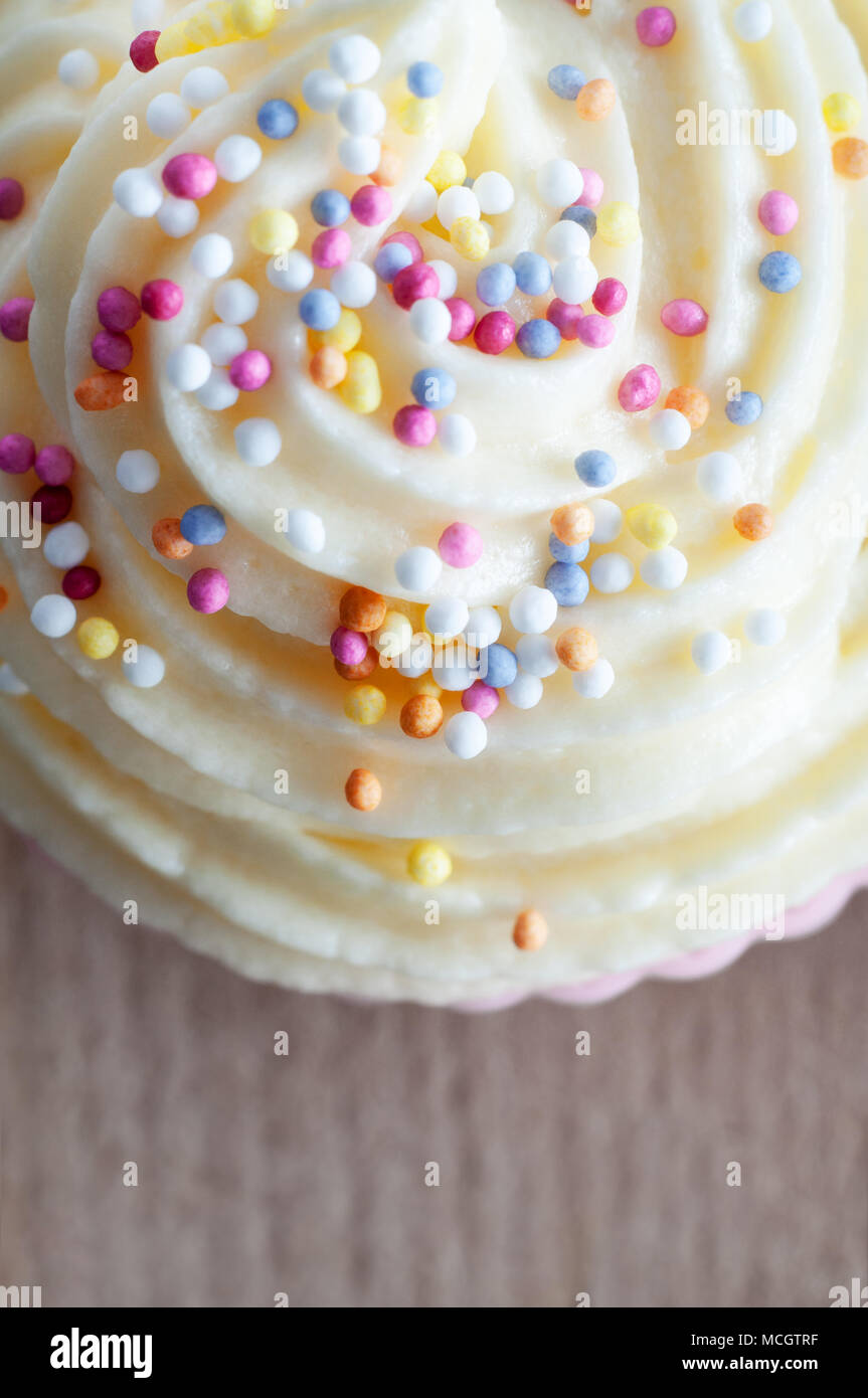 Close up of decorative cupcake topping of pale buttercream icing ...