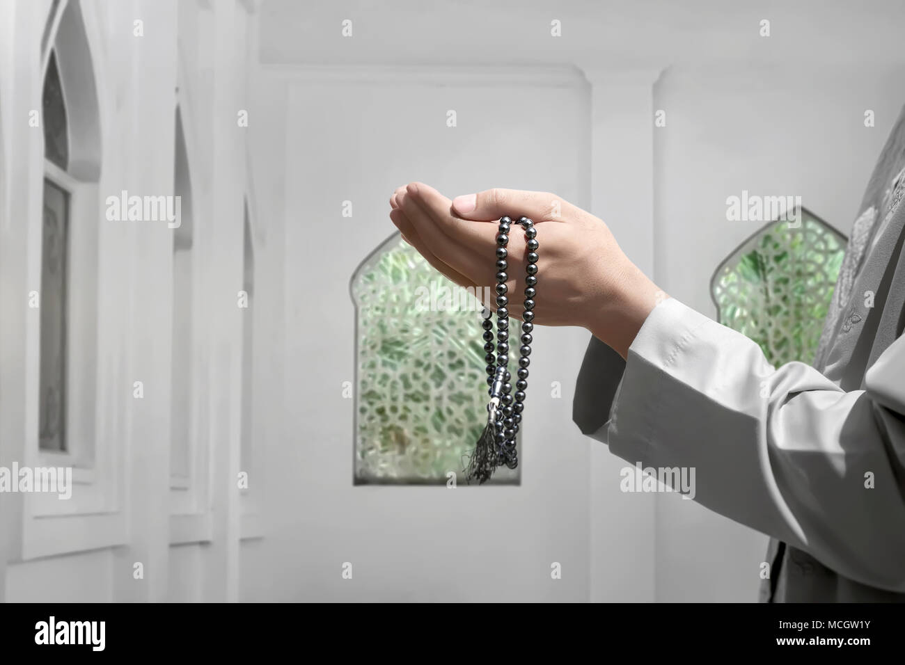 Muslim man raising hand and praying to god on the mosque Stock Photo ...