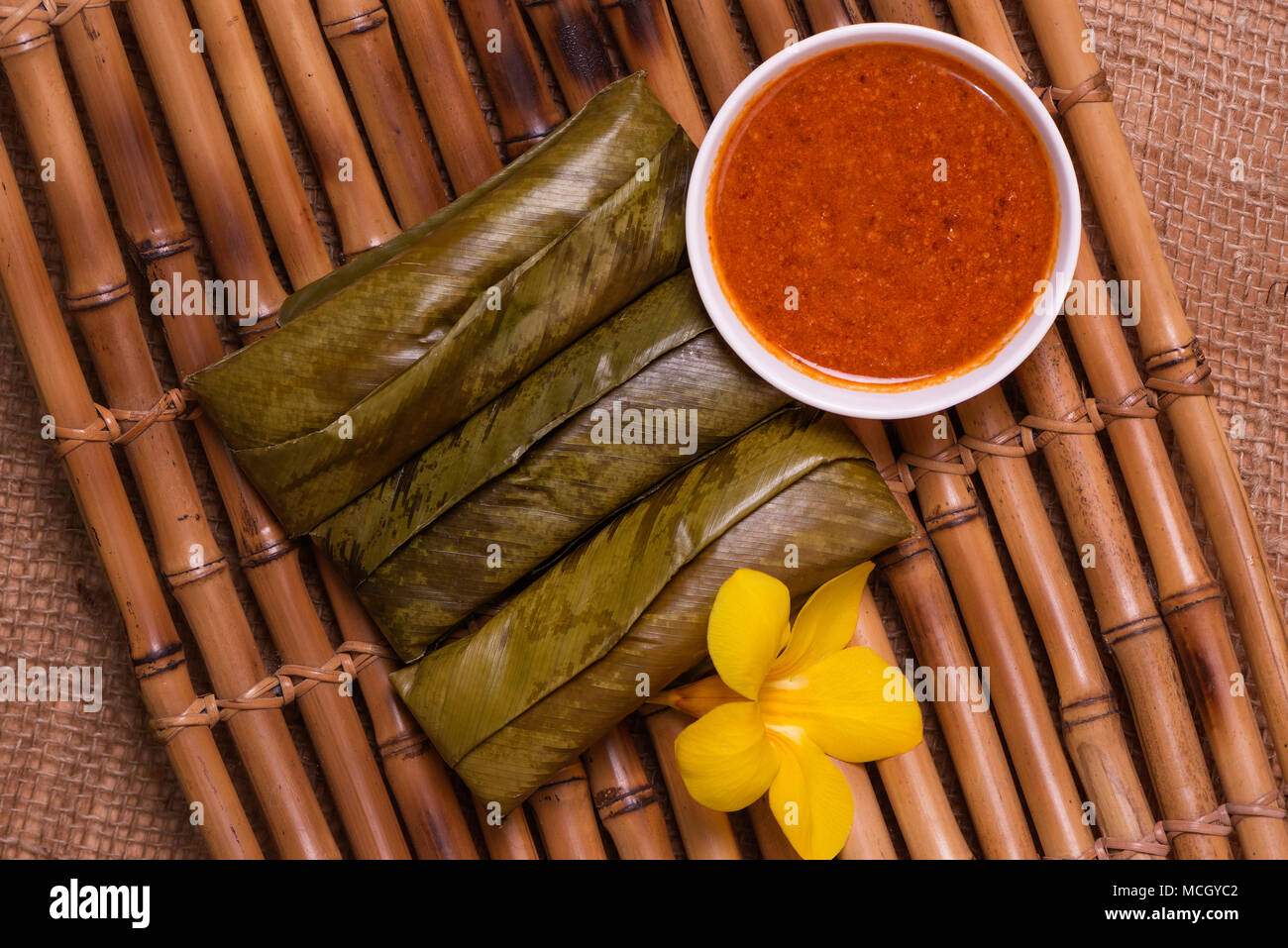 sticky rice wrapped in leaves and served with peanut sauce. Famous ...