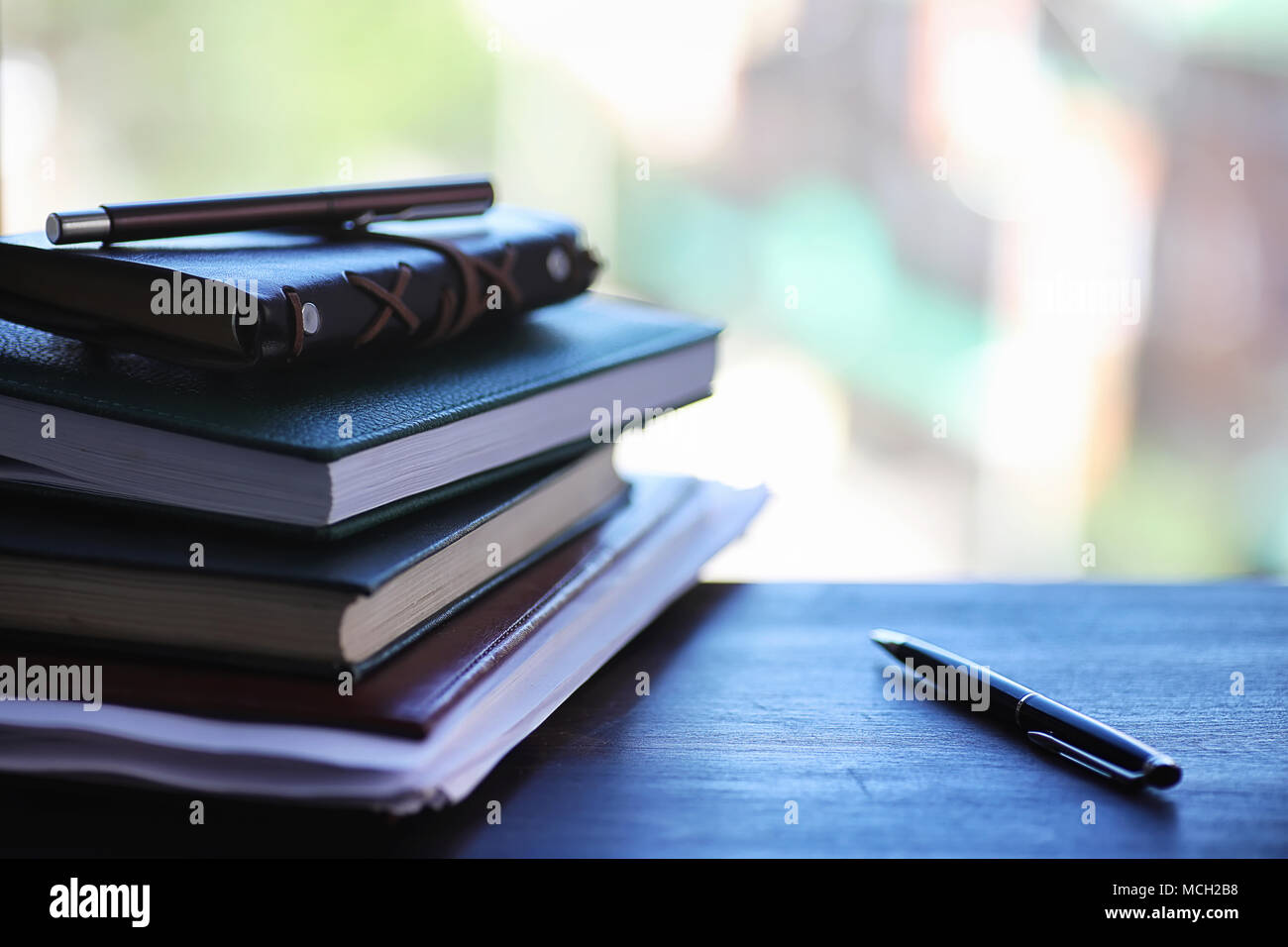 A stack of textbooks on the windowsill Stock Photo - Alamy