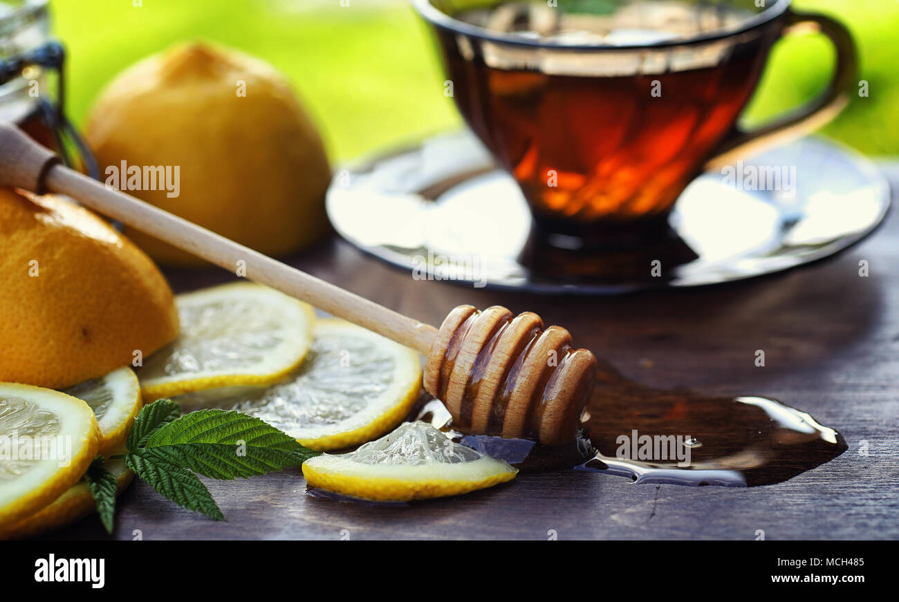 Tea with lemon and mint in nature. A cup of hot mint tea with le Stock ...