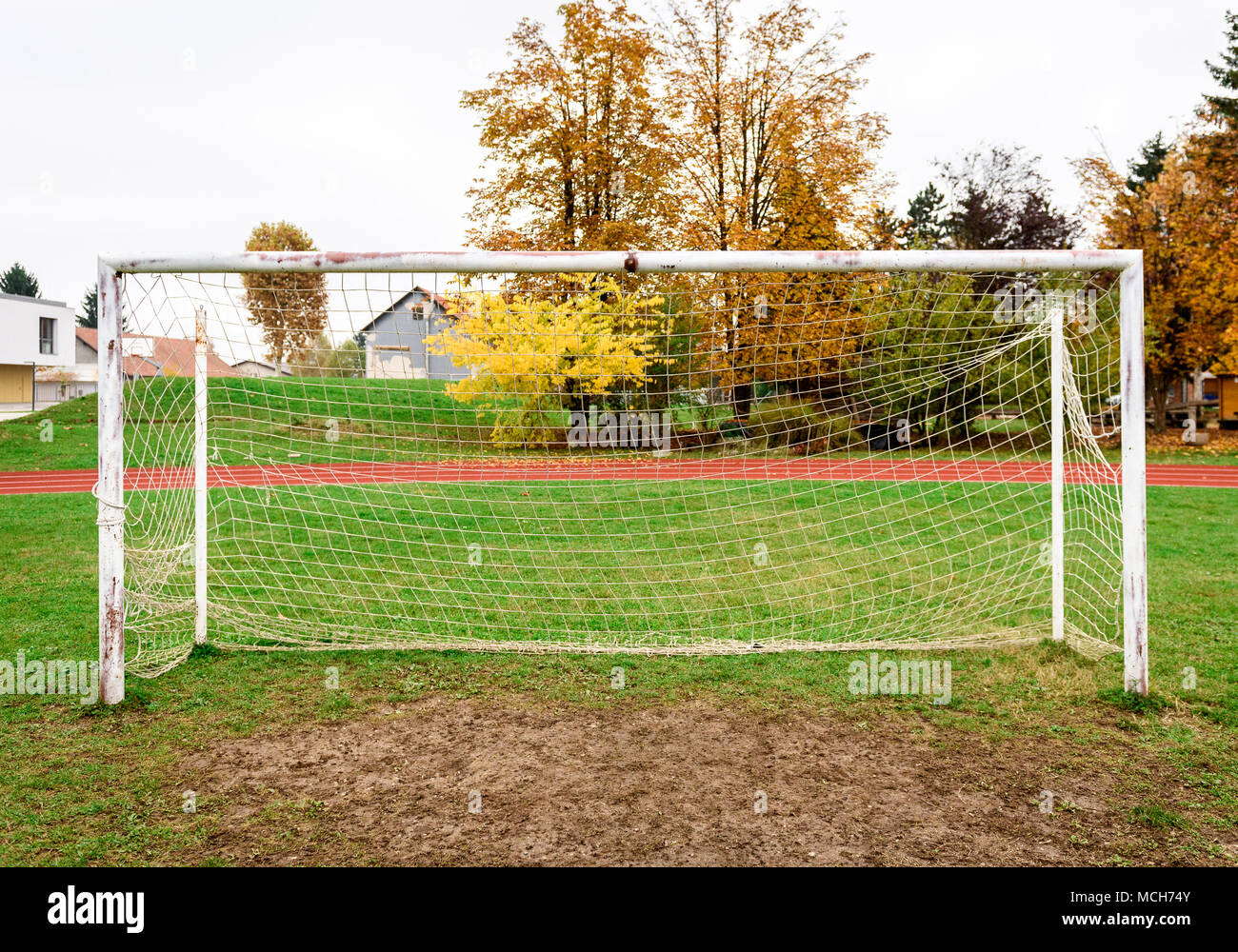 Old vacant football soccer goal gate in rural grass field. Old sports ...