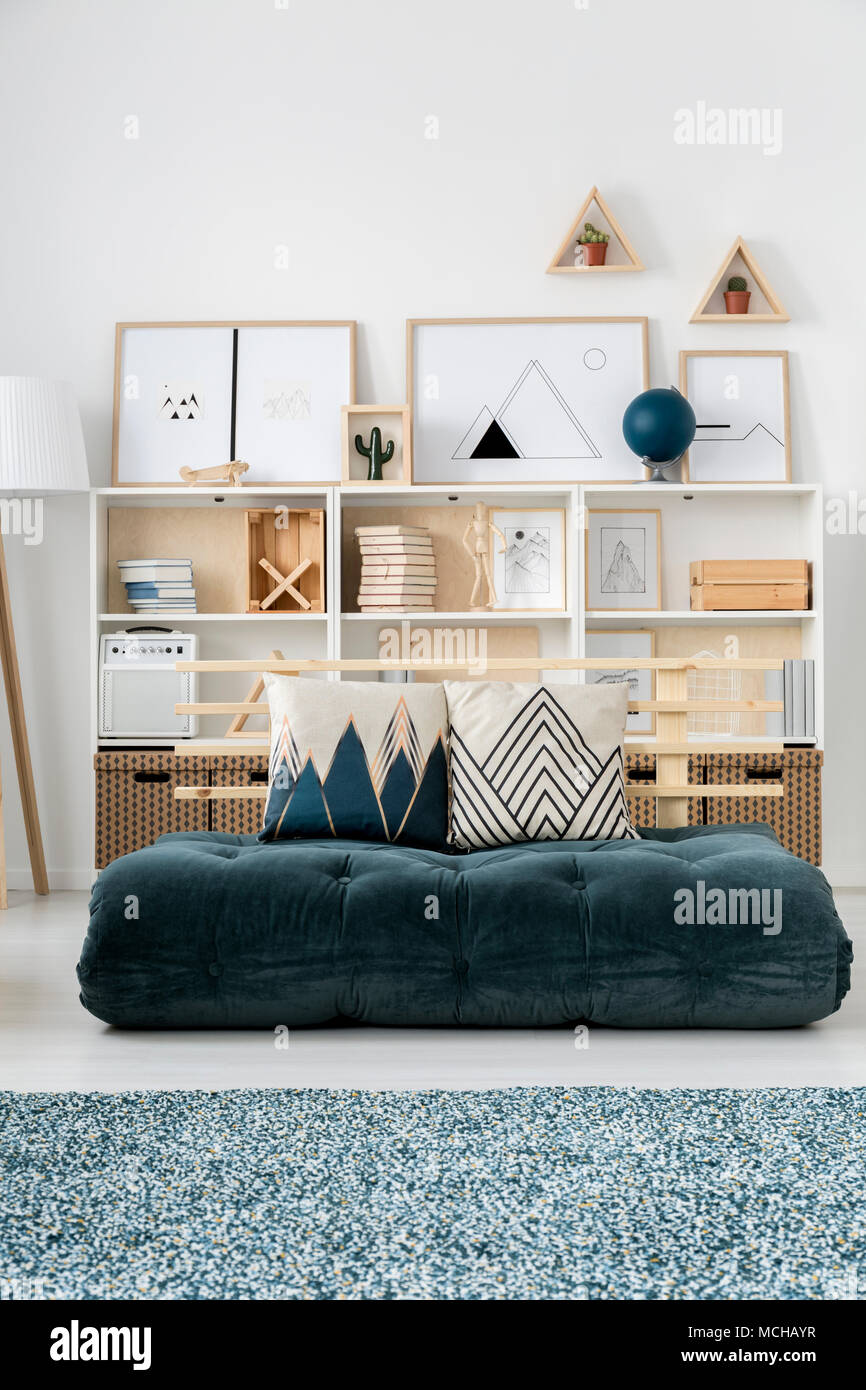 Simple living room interior with green futon instead of a sofa and ...