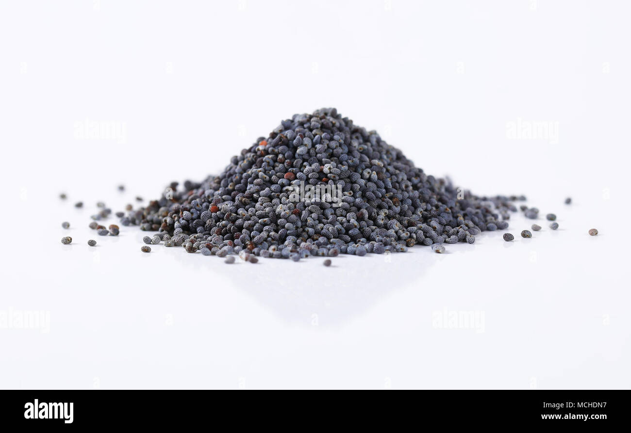 pile of poppy seeds on white background Stock Photo - Alamy