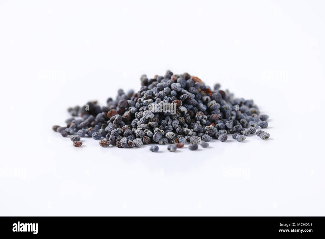 pile of poppy seeds on white background Stock Photo - Alamy