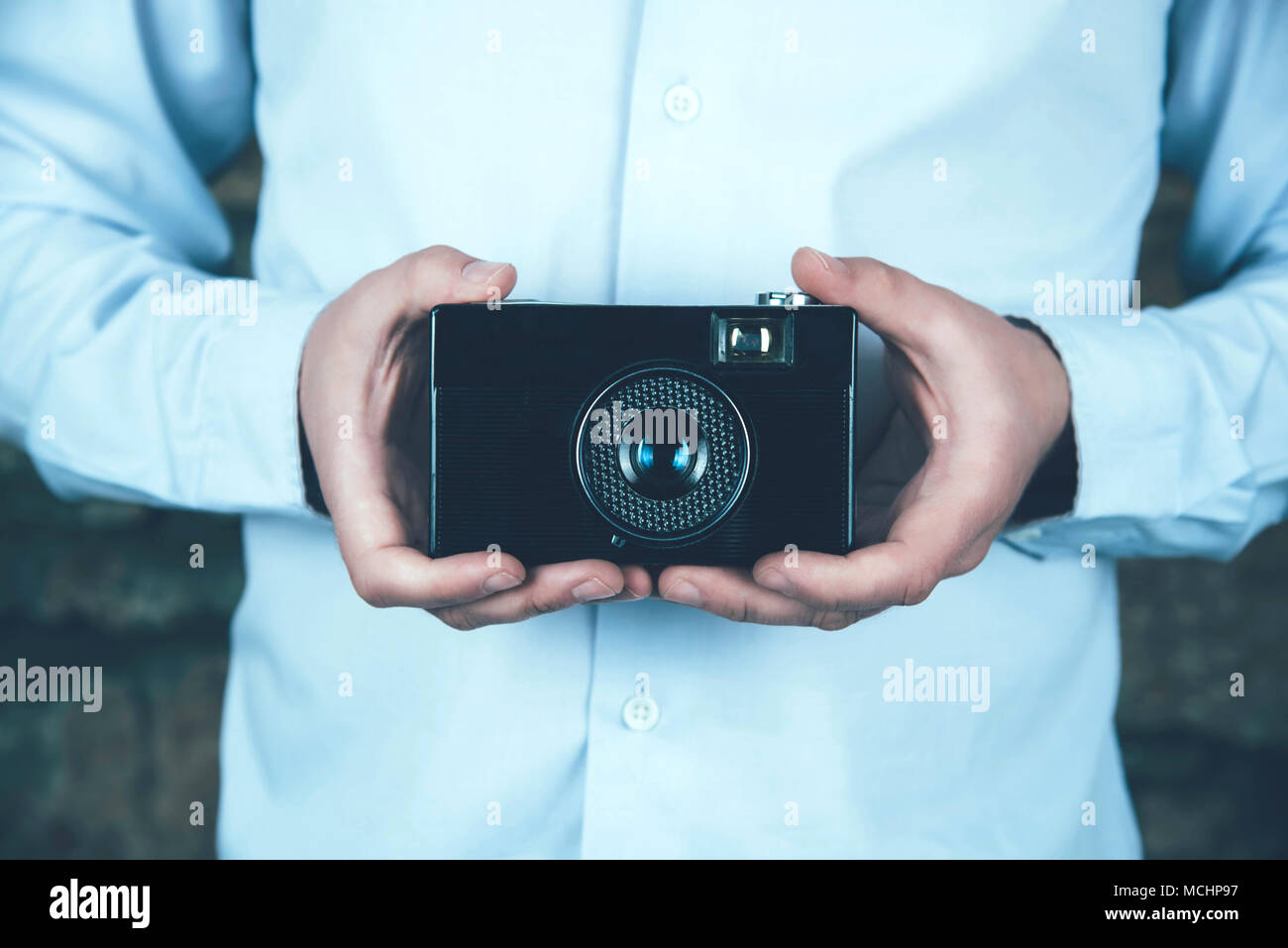 Hands holding retro camera, close up. Rustic background Stock Photo - Alamy
