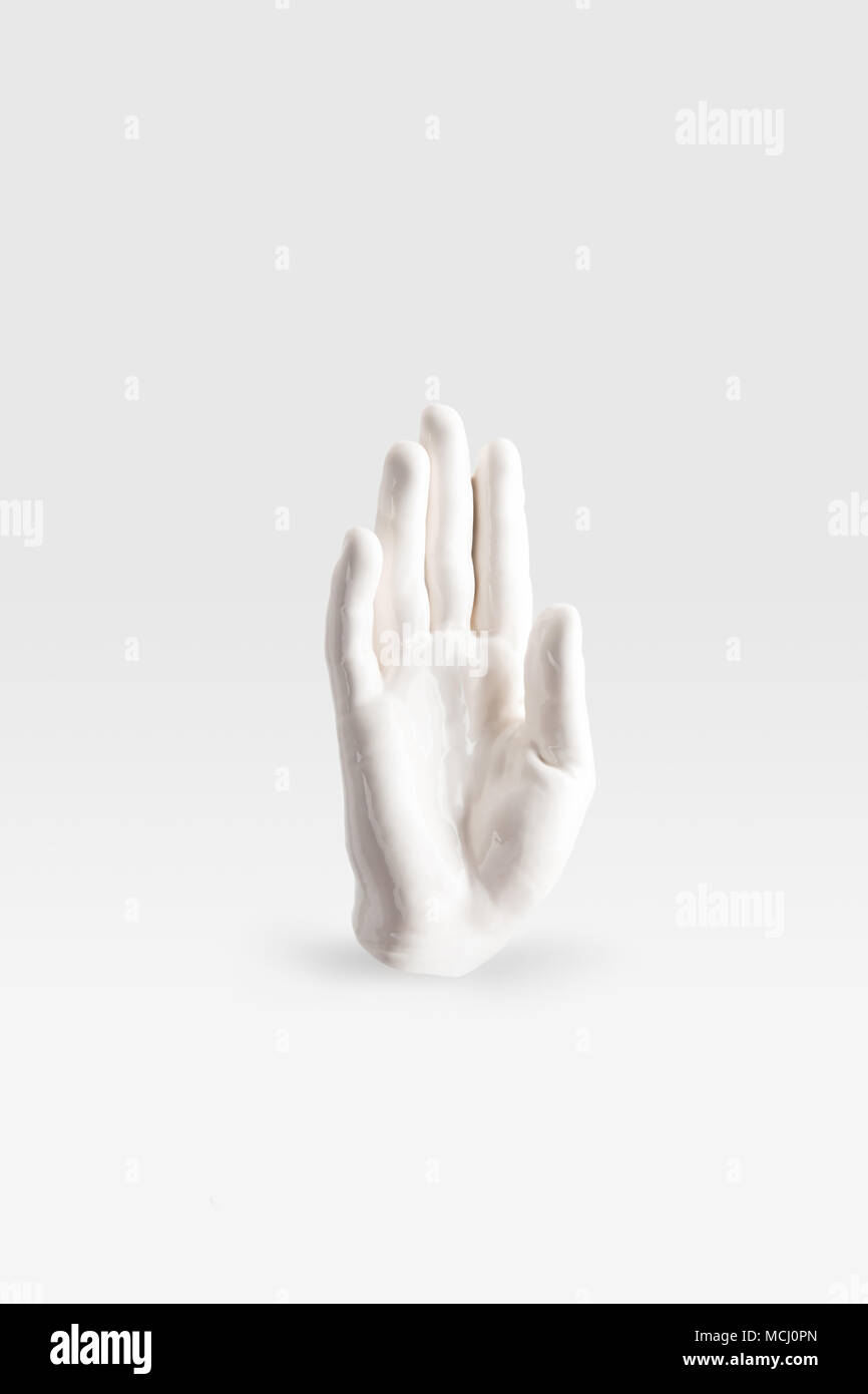 abstract sculpture in shape of human arm in white paint on white ...