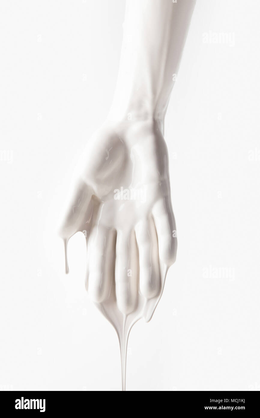 cropped image of female arm in white dripping paint isolated on white ...