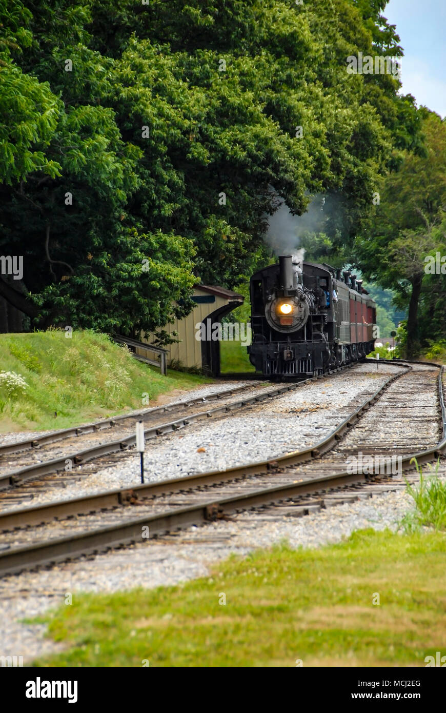 Steam Engine with Passenger Train Pulling into Station Puffing Smoke ...